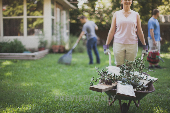 Woman removing debris with a wheelbarrow - Stock Photos | Pearl Woman removing debris with a wheelbarrow - Stock Photos | Pearl